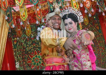 A couple in traditional Bugis dress in a tunnel. Bugis is one of the ...