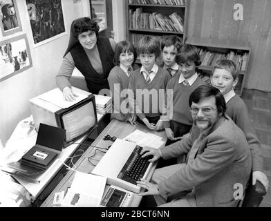 Primary school pupils using computers in classroom. Children in ...