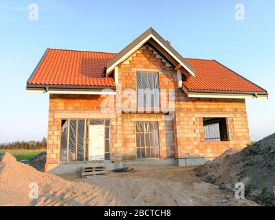 Modern house constructions. Half finished house with roof during ...