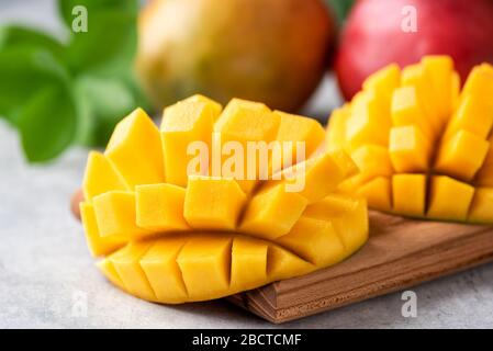 Fresh mango fruit with sliced diced mango chunks on a plate or on ...