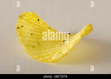 Wavy potato chip isolated on the dark background Stock Photo - Alamy