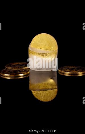 Golden Bitcoin Coin On Frozen Ice Stock Photo - Alamy