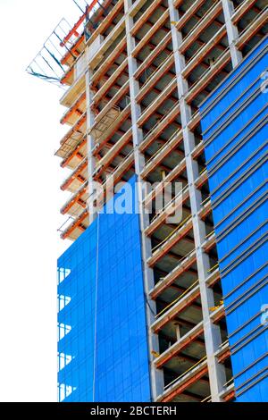 high-rise work on an apartment building. A construction worker inspects ...