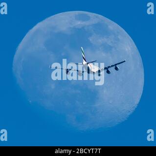 Airliner in flight with a waxing moon in the background, Germany ...