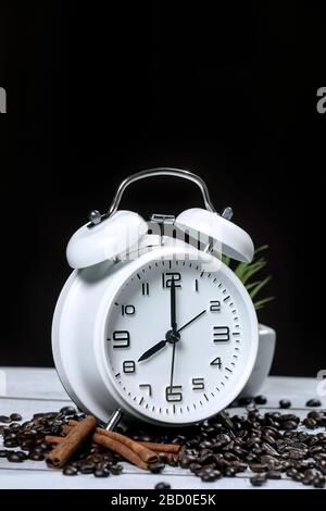 Retro alarm clock with coffee beans. Morning coffee after waking up ...