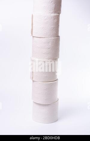 Toilet paper Rolls stacked on a toilet lid in a residential bathroom ...