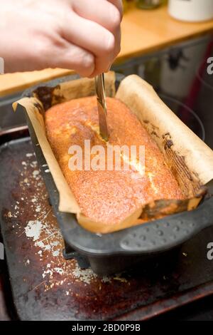 Baking paper with bread and knife on white wooden background Stock ...