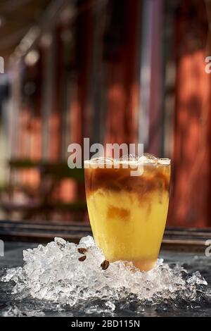 Layered alcoholic cocktails, on a wooden board on a black background ...
