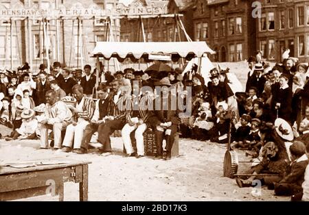 Pierrots on the beach, Blackpool, Victorian period Stock Photo - Alamy