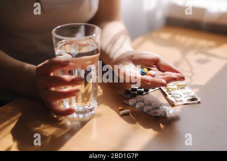 Close-up of sick pretty girl drinking water from glass Stock Photo - Alamy
