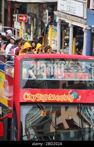 Red bus of City Sightseeing Cape Town and the skyline of Cape Town ...