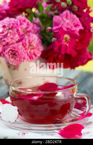 Rose tea with fresh roses on wooden background Stock Photo - Alamy