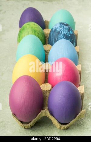 Colorfully painted Easter eggs on wooden table on white background ...