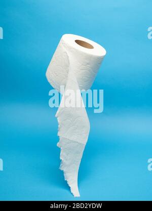 Torn off white toilet paper roll on minimalistic blue background Stock ...