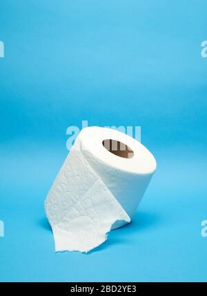Torn off white toilet paper roll on minimalistic blue background Stock ...