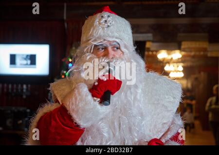 caucasian singing man in christmas sweater and santa hat isolated on ...