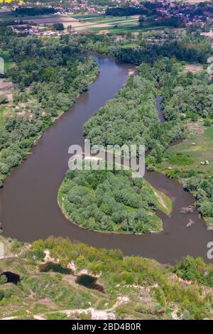 Aerial view of meandering lowland river in the lush green vegetation of ...