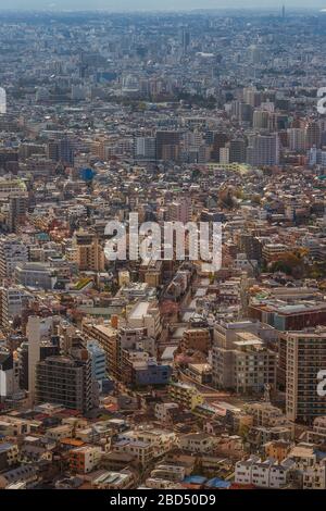 Tokyo endless suburbs, a wall of concrete buildings view from above ...