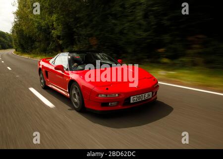 A red Honda NSX driving at speed Stock Photo - Alamy