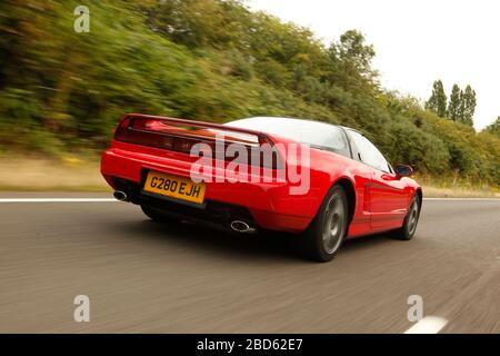 A red Honda NSX driving at speed Stock Photo - Alamy