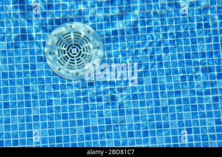 Drain hole in the pool with blue tile. Pool filtration system. Clean ...