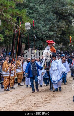 Yabusame (Japanese horseback archery) archer prepares his arrow to ...