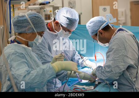 NHS Surgeons perform laparascopic surgery on a patient's stomach while ...