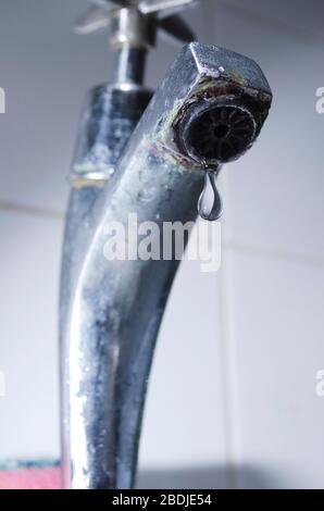 Water dripping from tap with splash on light background Stock Photo - Alamy