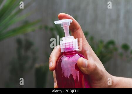 Man using red soap for disinfecting hands Stock Photo - Alamy