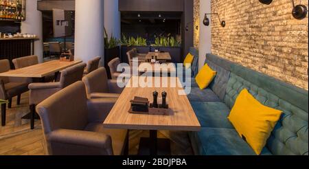 Cute restaurant interior with sofas and wooden tables Stock Photo - Alamy