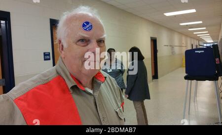 Hal Marshall playfully displays his commitment to voting after casting ...
