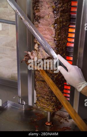 Gyros cutting with knife on fast food Stock Photo - Alamy