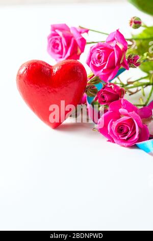 Kraft box and pink roses on white table, concept of Valentine's Day ...