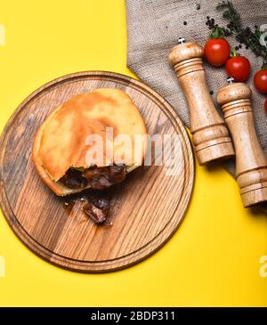 Roasted meat in small dough pocket on wooden board Stock Photo - Alamy
