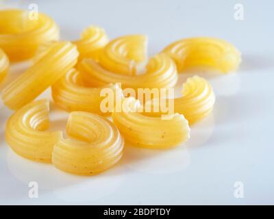 Raw spiral tortiglioni pasta isolated on black background, top view ...