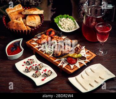 Juicy meat rolls cooking on metal skewers over hot charcoal with ...