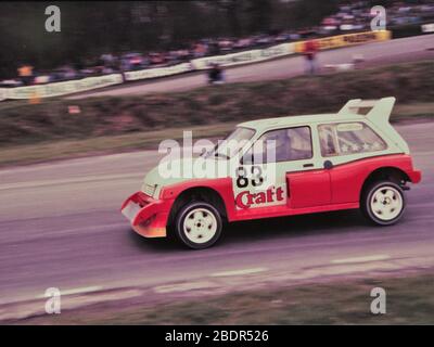 1986 MG Metro 6R4 Group B rally car on the forest stage with driver ...