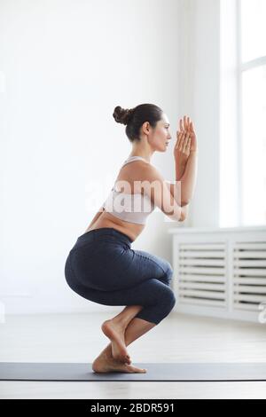 Young smiling women exercising yoga poses on sunny beach by ocean Stock ...