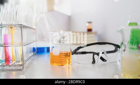 Scientific experiment tools on the desk. Empty blackboard. Education ...