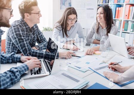 business partners discussing projects and ideas at meeting Stock Photo ...