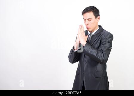 Man in suit praying. White background, full body Stock Photo - Alamy
