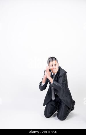 Man in suit begging. White background, full body Stock Photo - Alamy