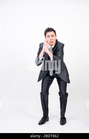 Man in suit begging. White background, full body Stock Photo - Alamy