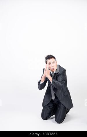 Man in suit begging. White background, full body Stock Photo - Alamy