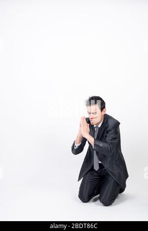 Man in suit praying. White background, full body Stock Photo - Alamy