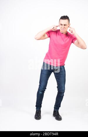 Man disgusted by noise. White background, Medium shot Stock Photo - Alamy