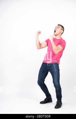 Euphoric man celebrating something. White background. Full body Stock ...