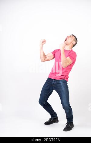 Euphoric man celebrating something. White background. Full body Stock ...