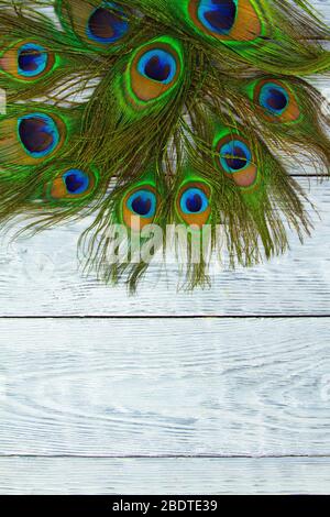 peacock feathers on wooden background Stock Photo - Alamy