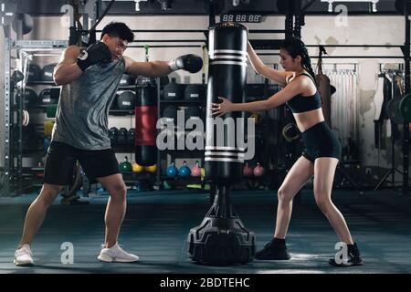 young adult man boxing in gym with his trainer Stock Photo - Alamy